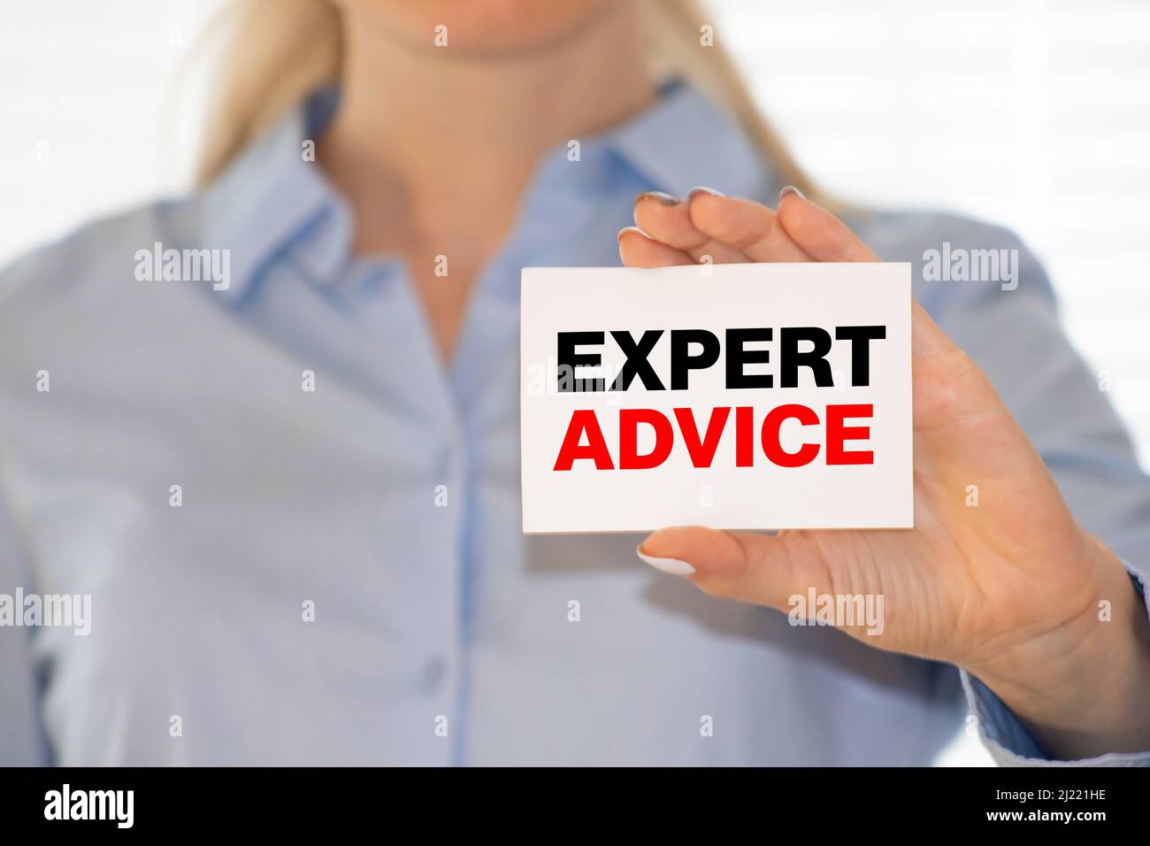 EXPERT ADVICE, message on the card shown by a man Stock Photo - Alamy