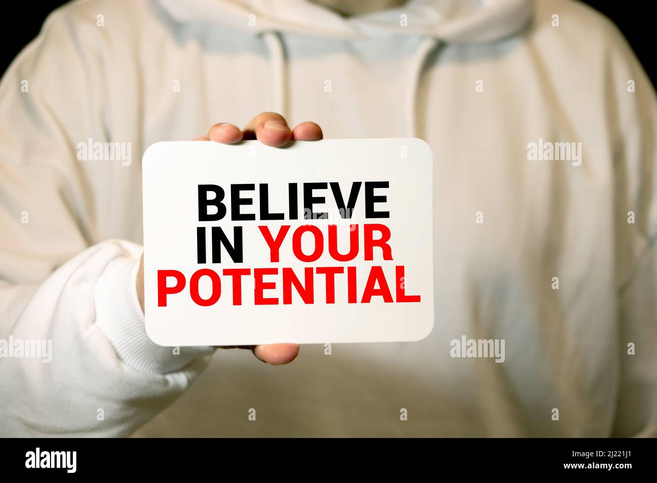 conclusion men have a paper with text BELIEVE IN YOUR POTENTIAL Stock ...