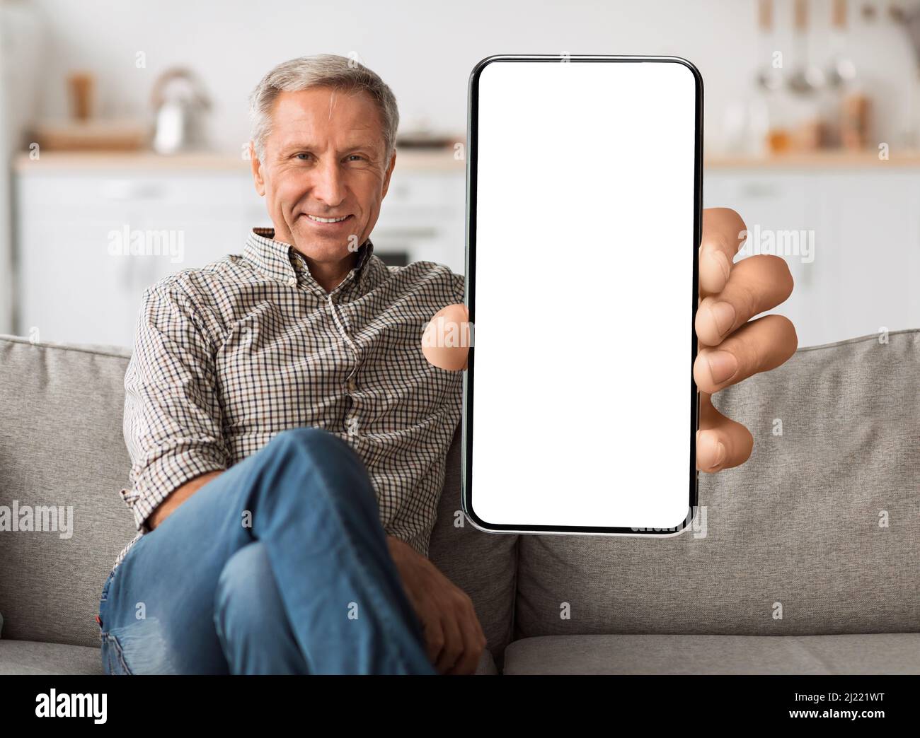Cool mobile application. Smiling senior man showing cellphone with ...
