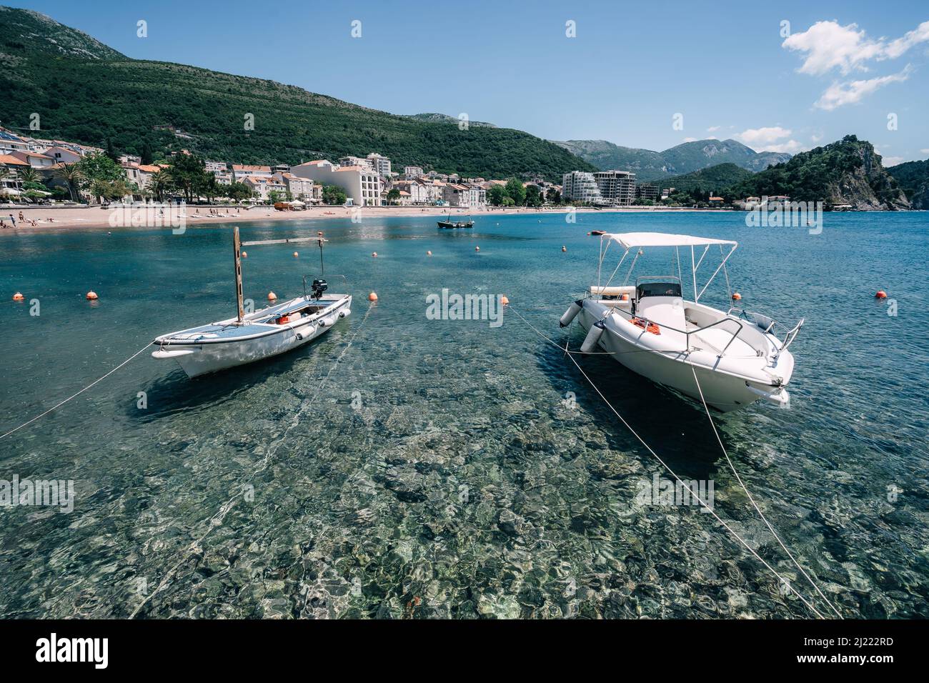 Old fishing boats in clear water in Montenegro Stock Photo - Alamy