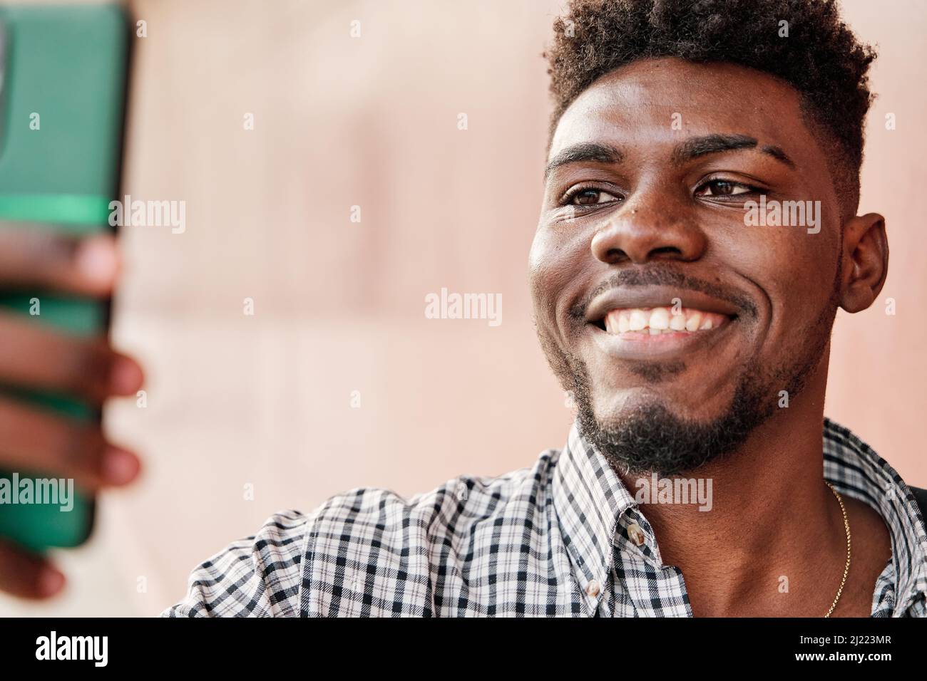 man with jacket over his shoulder taking a selfie Stock Photo - Alamy