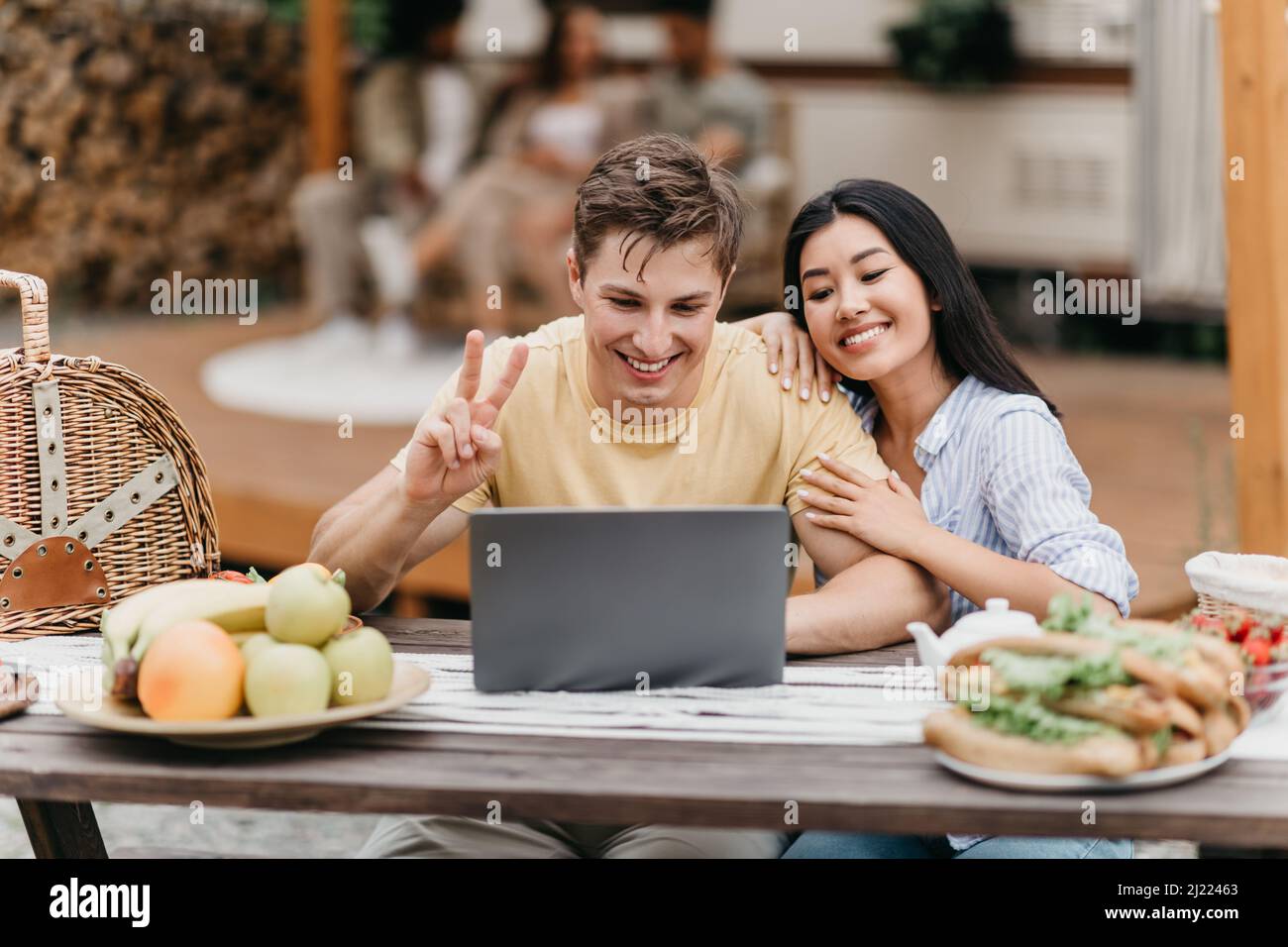 Millennial diverse couple using laptop computer near motorhome, video ...