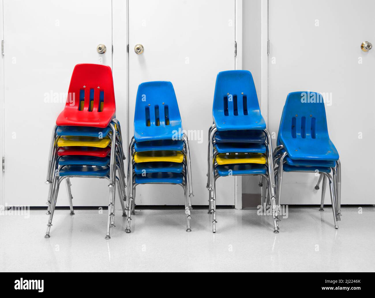Four piles of stacked plastic chairs Stock Photo - Alamy