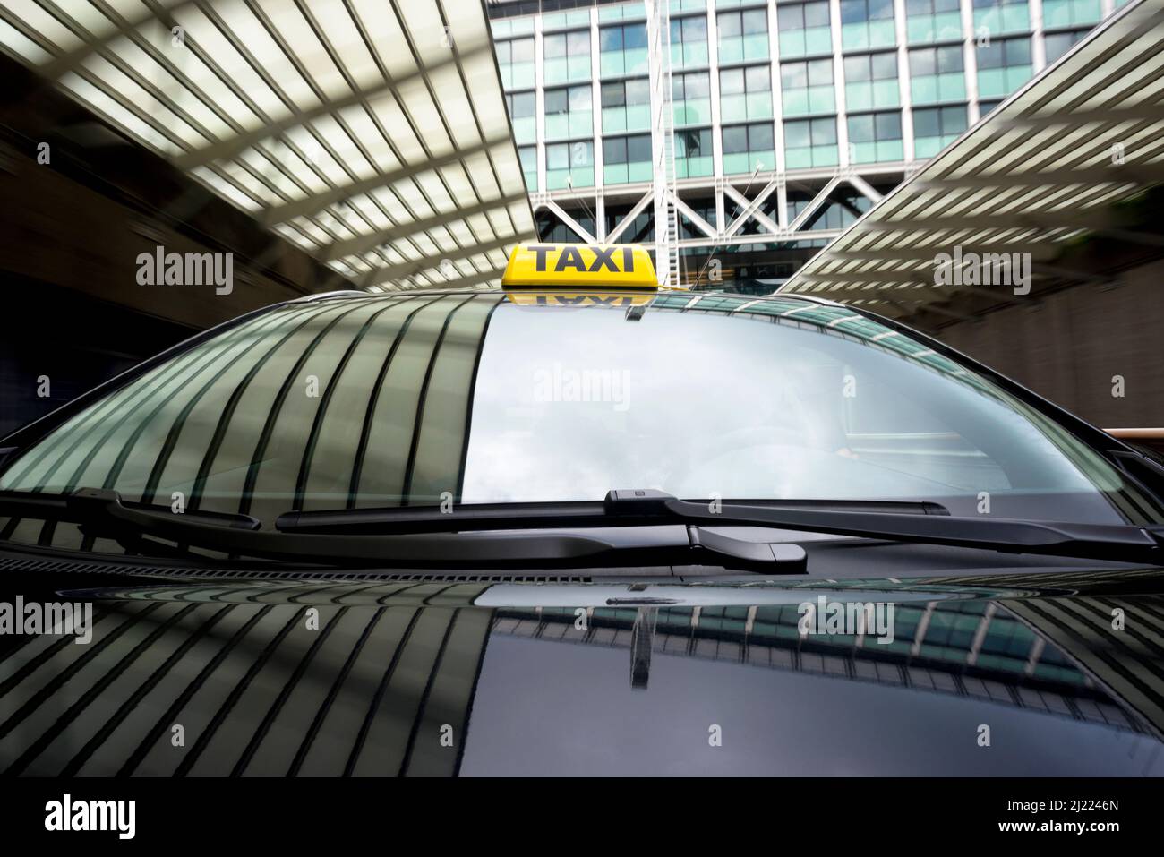Taxi cab emerging from a garage underneath an office building Stock ...