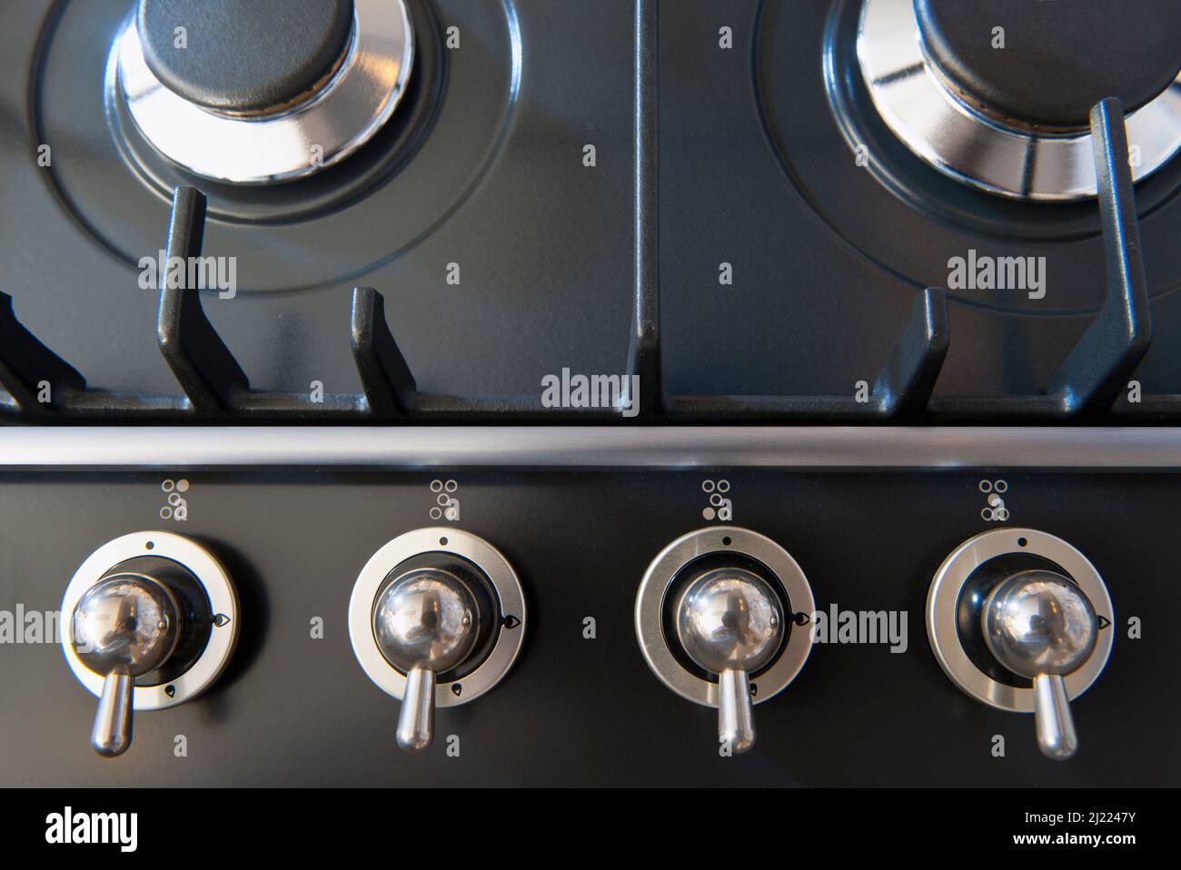 A kitchen stove with gas burners and control knobs Stock Photo - Alamy