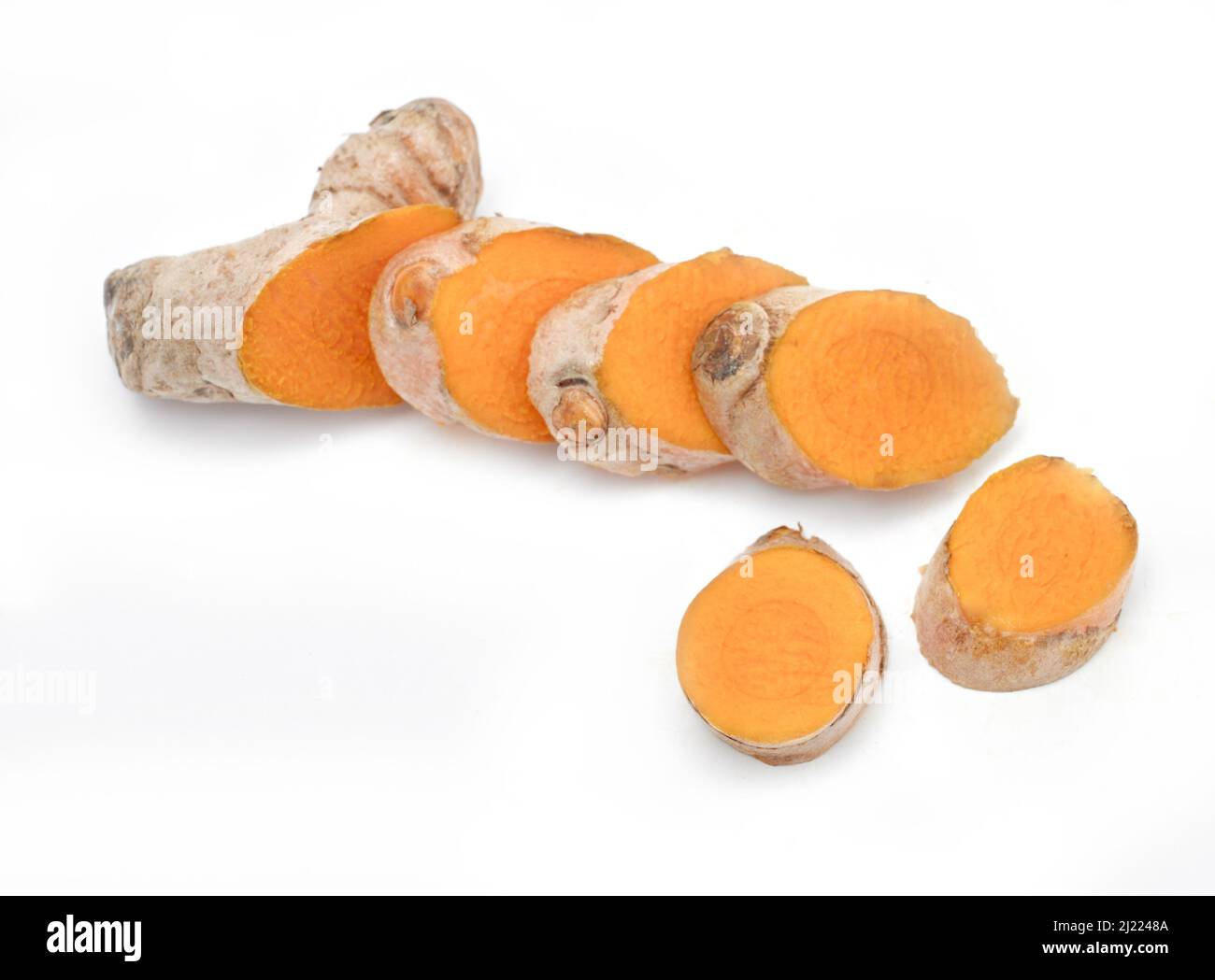 Sliced Tumeric on a white background Stock Photo - Alamy
