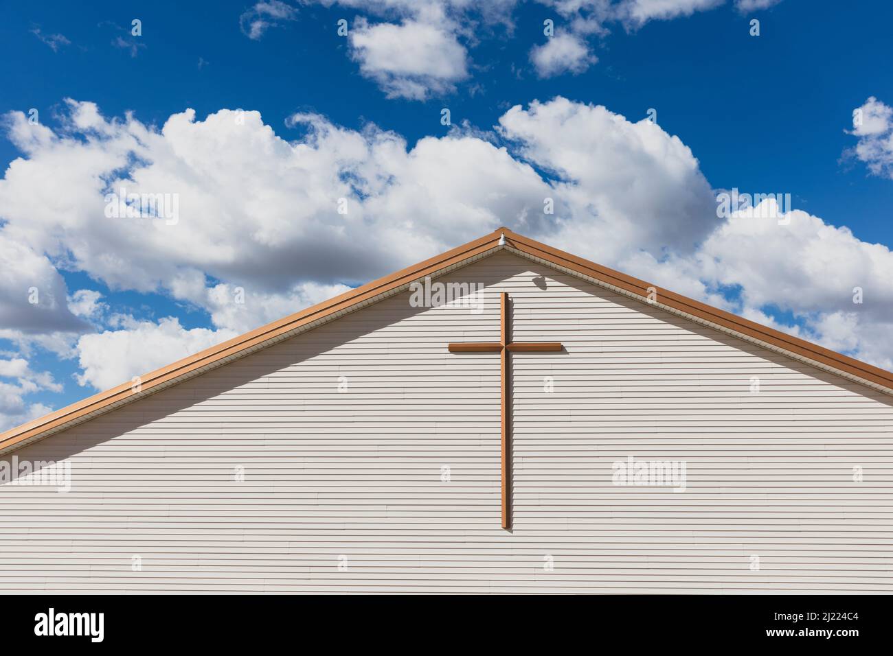 A large cross on the exterior wall of a church in a small town Stock ...