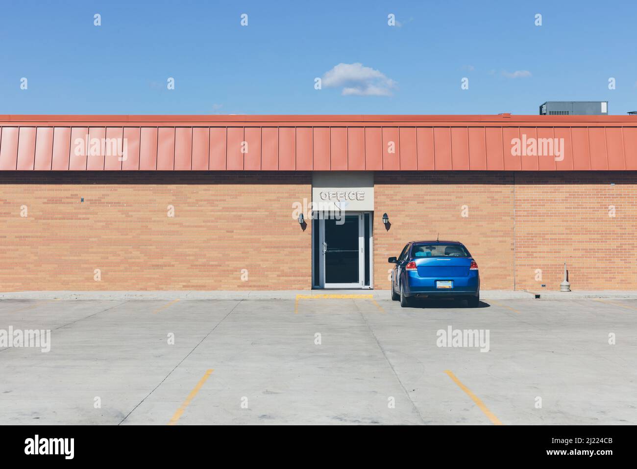 Parked blue car in a parking lot outside a building Stock Photo - Alamy