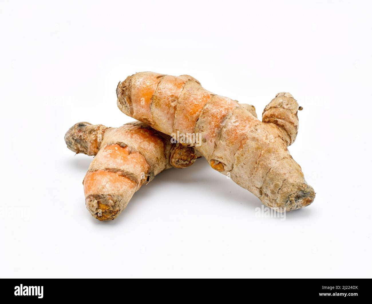 Tumeric bulbs on a white background Stock Photo - Alamy