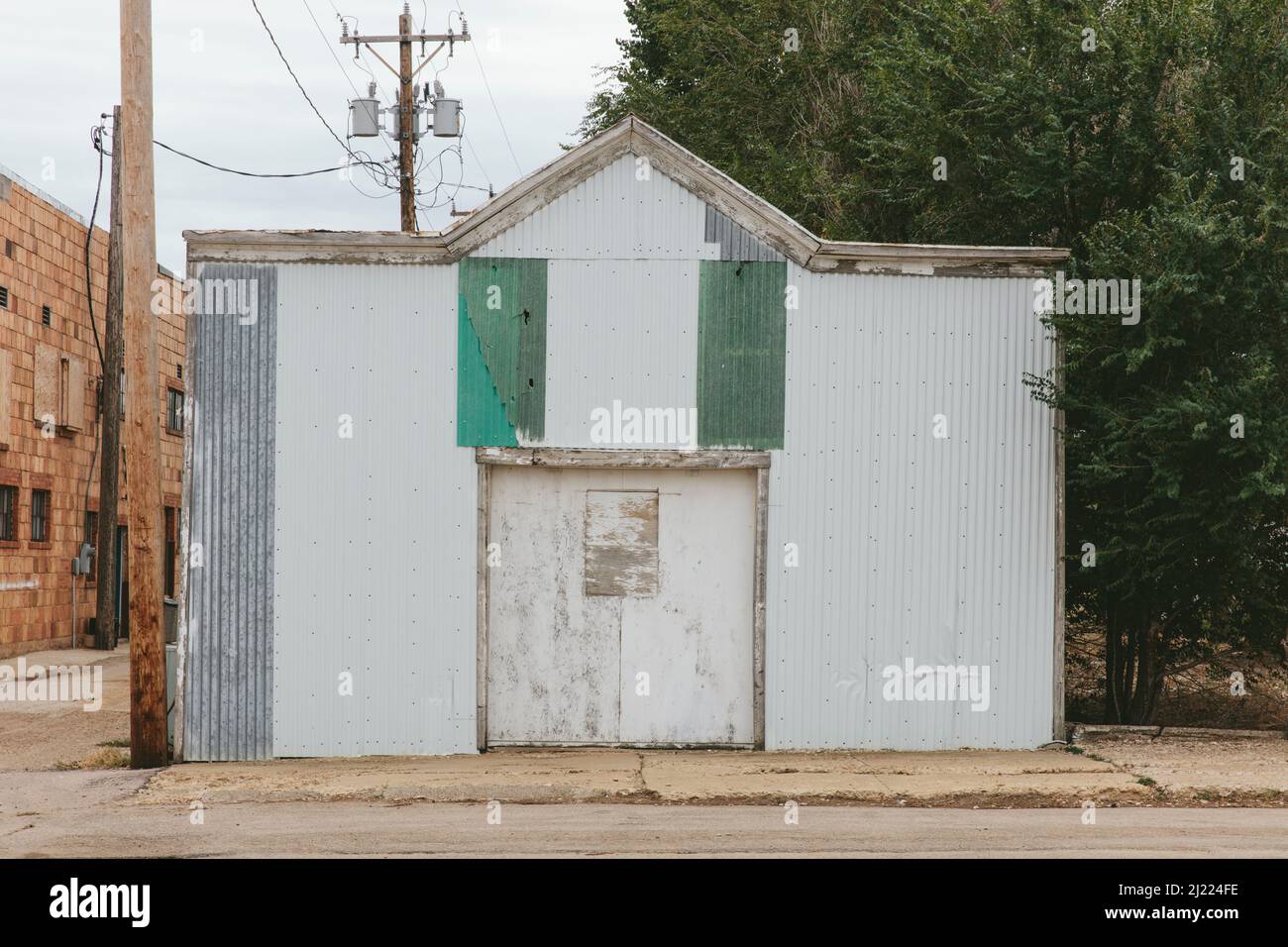 A small metal building boarded up on a sideway in a small town Stock ...