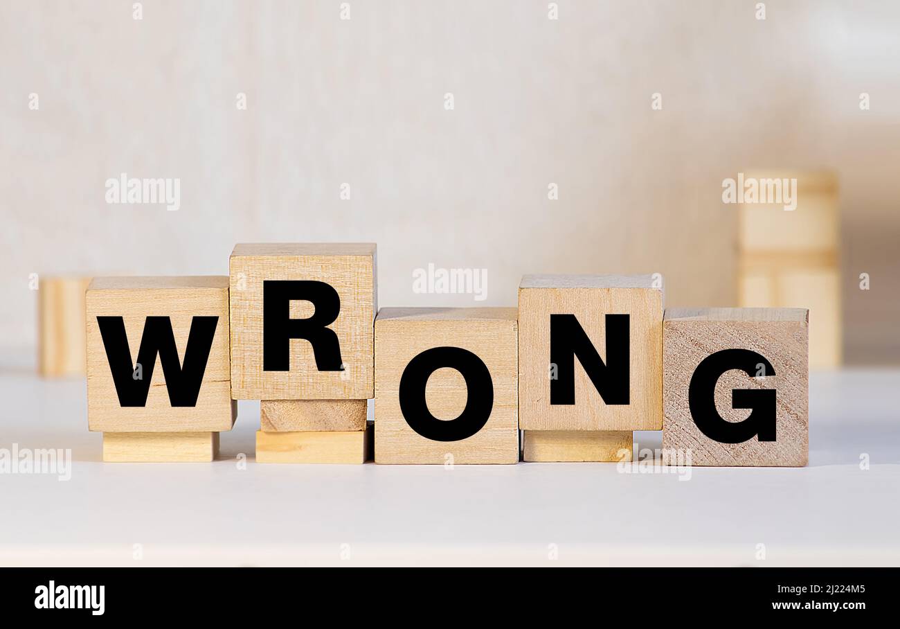 Letter block in word wrong on wood background Stock Photo - Alamy