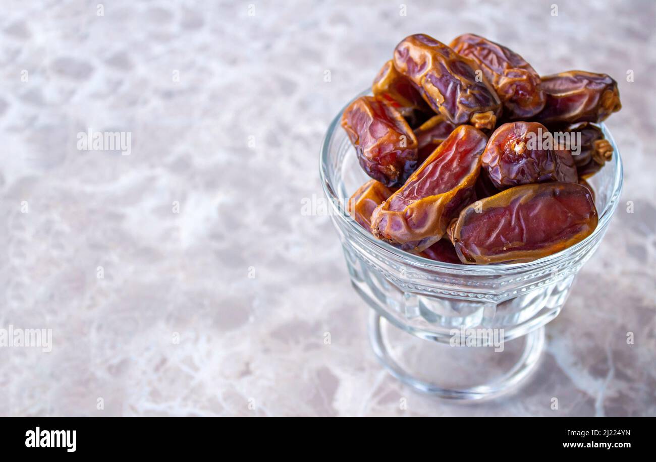 Dried date fruits on marble table. Closeup photo of ripe dates with ...