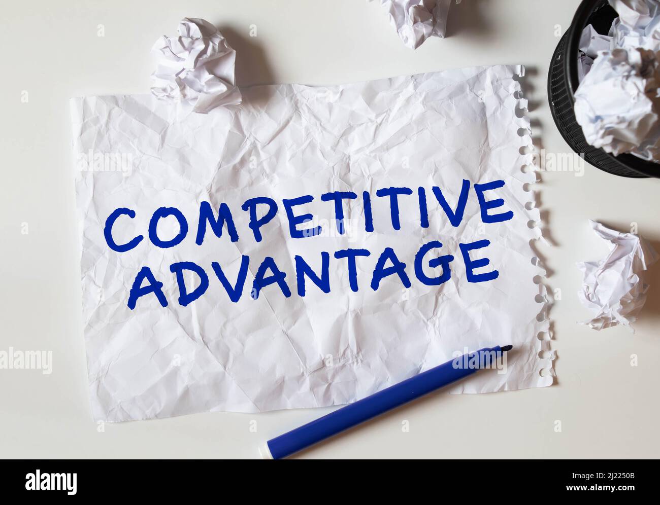 competitive advantage. Text on white paper on wood background Stock ...