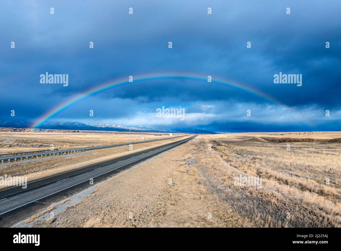 An interstate road reaching to the horizon through a flat landscape ...