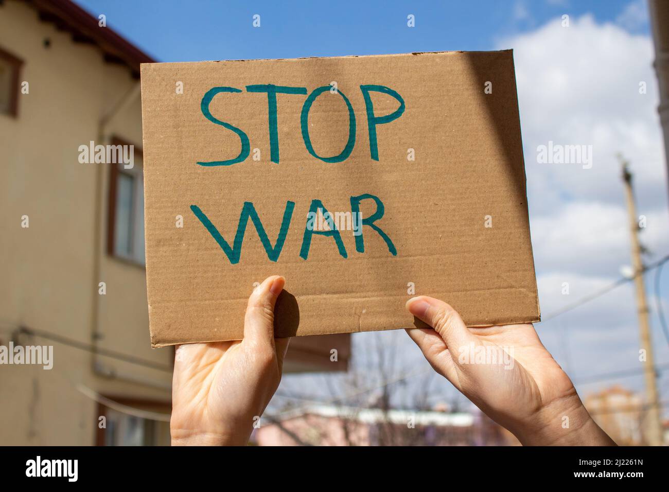 Hand holding Stop War written placard. Demonstration against to war ...