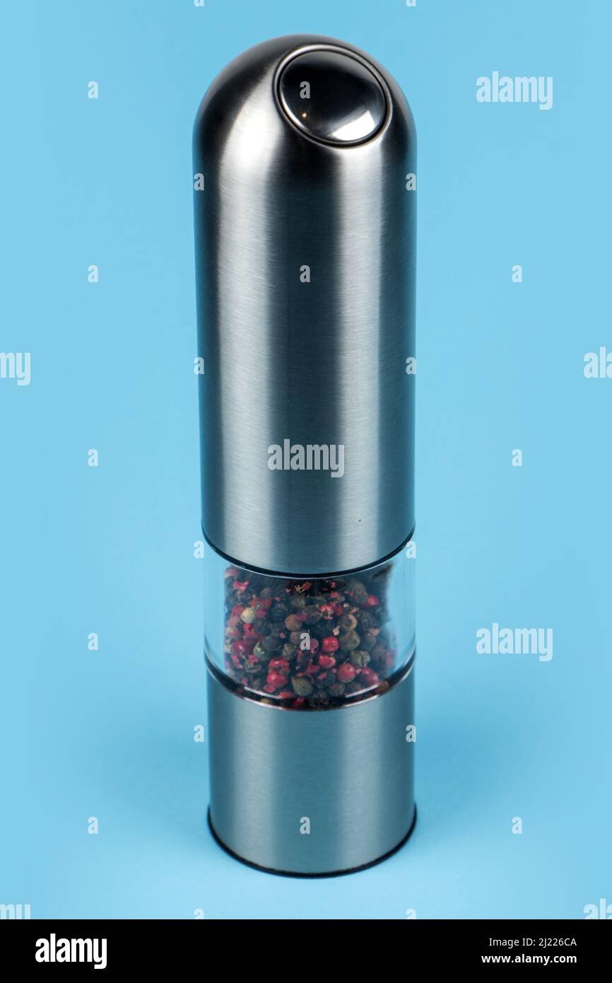 Pepper silver grinder on blue background Stock Photo - Alamy