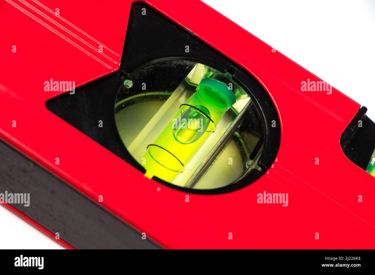 Red building level isolated on white background Stock Photo - Alamy