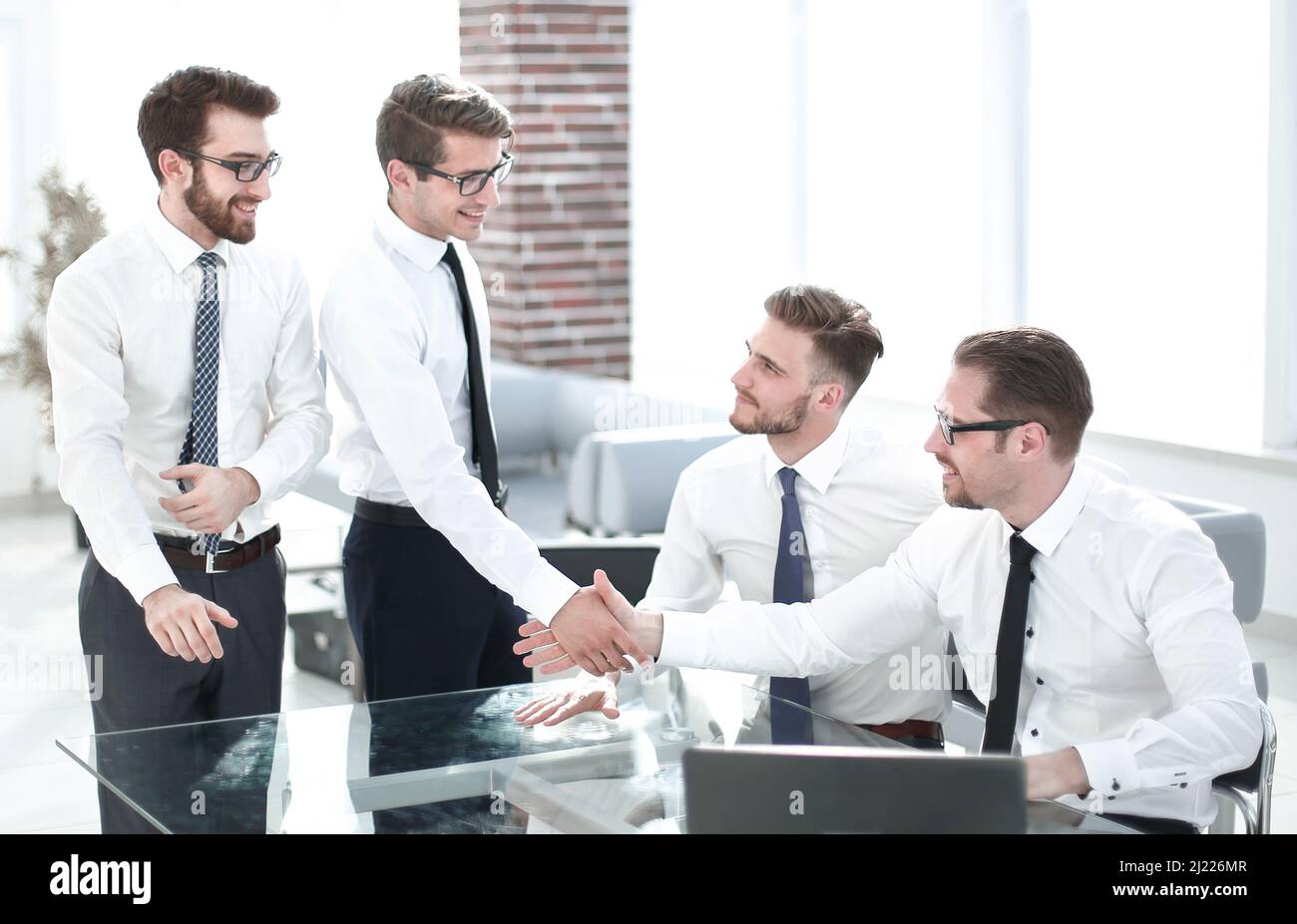 handshake colleagues in the workplace Stock Photo - Alamy