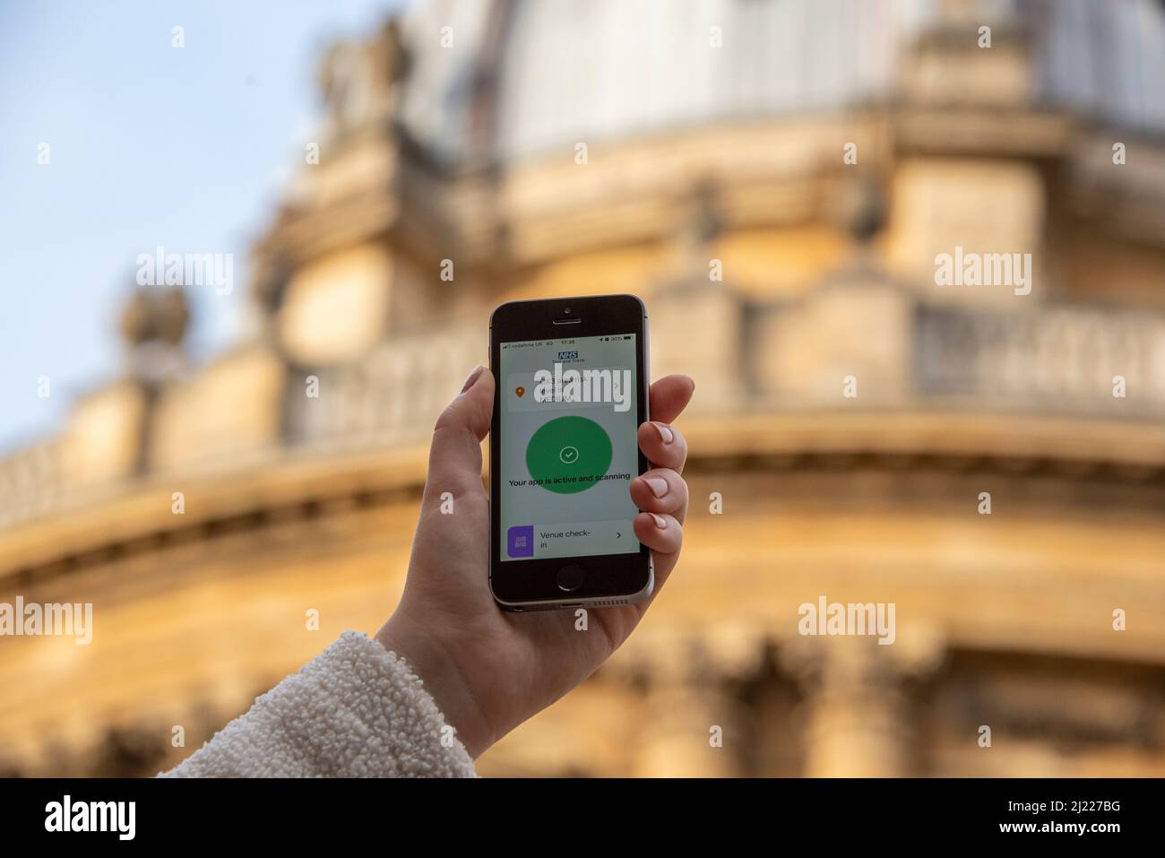 Using the NHS Covid app on an iPhone outside the Radcliffe Camera ...