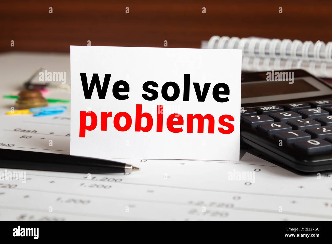 Notebook with text inside Problem Solving on table with coffee, laptop ...