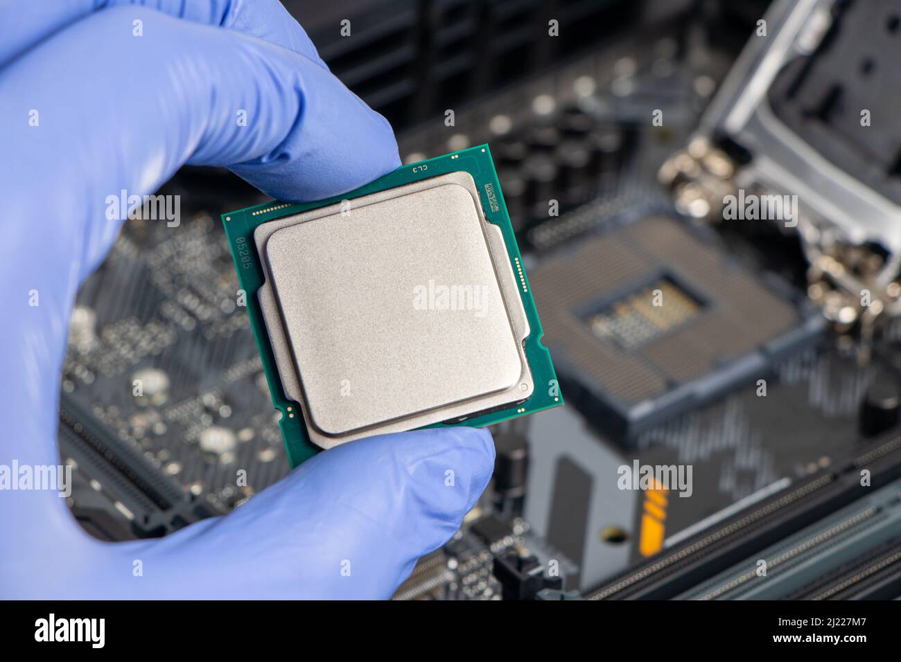 Plug in CPU microprocessor to motherboard socket. Technological ...