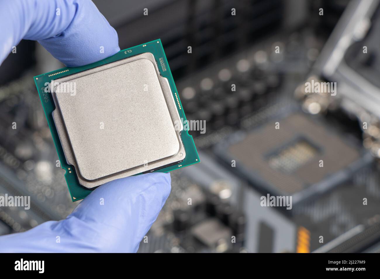 Plug in CPU microprocessor to motherboard socket. Technological ...