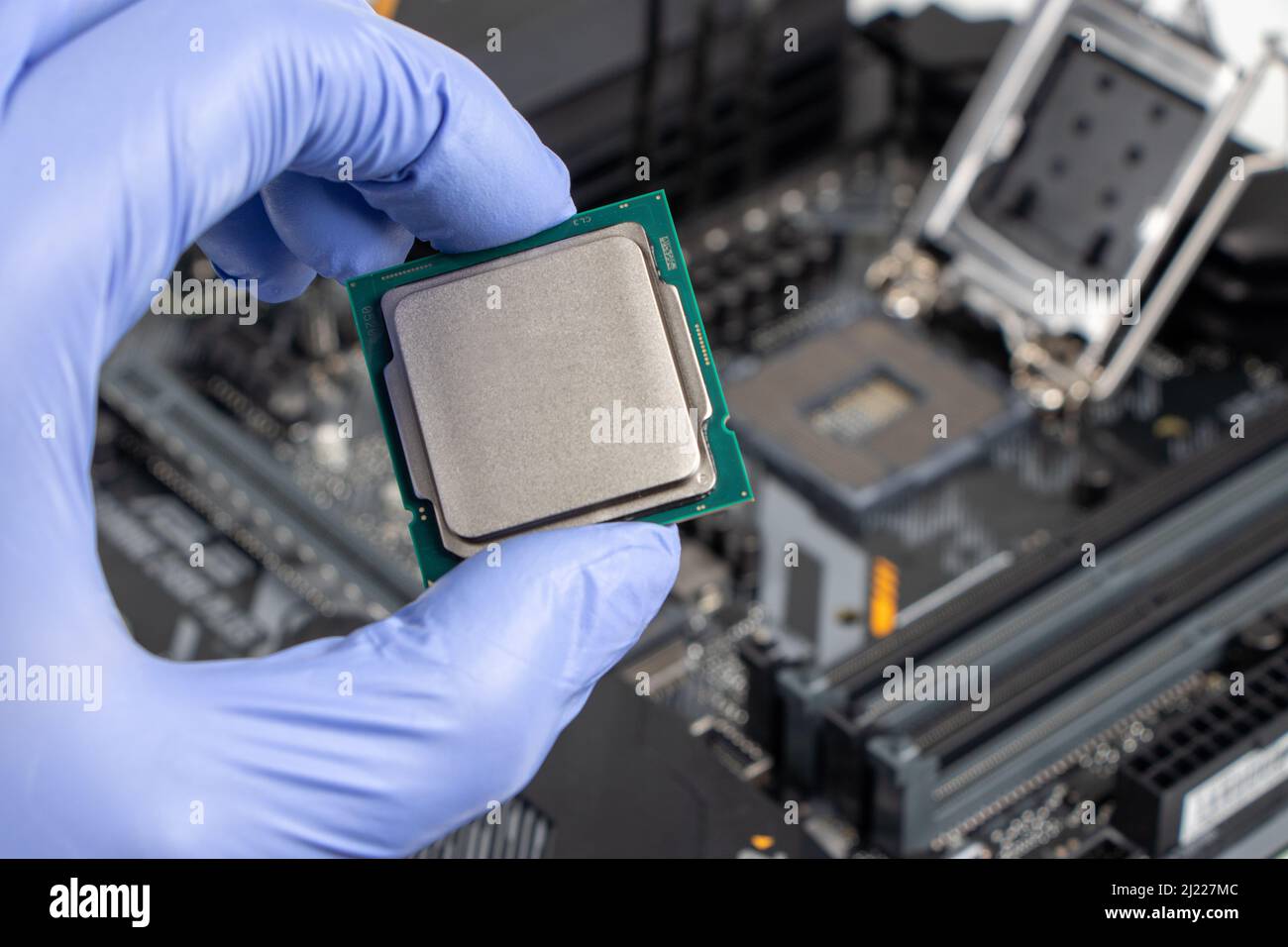 Plug in CPU microprocessor to motherboard socket. Technological ...