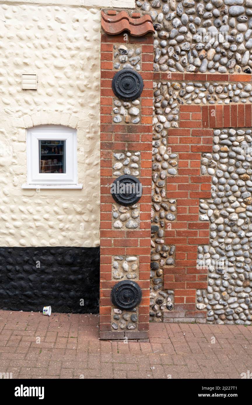Old black discs/ pattress on side of a building/ houses to help ...