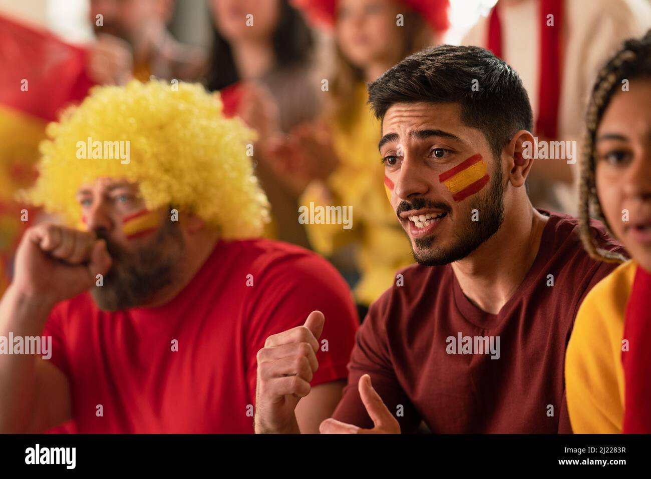 Nervous football fans supproting spanish national team in live soccer ...