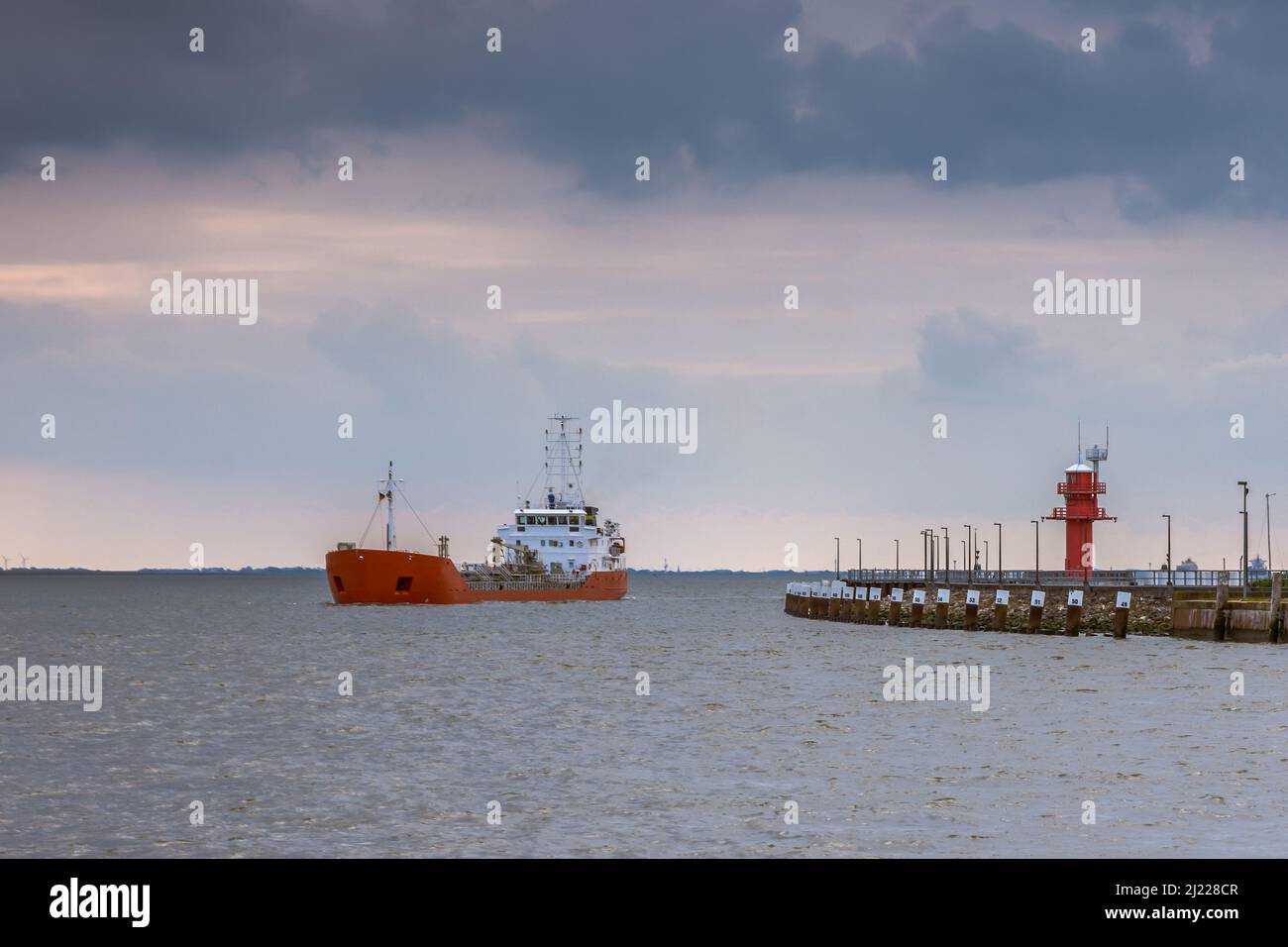 Tank vessel and lighthouse, Brunsbuettel, Schleswig-Holstein, Germany ...