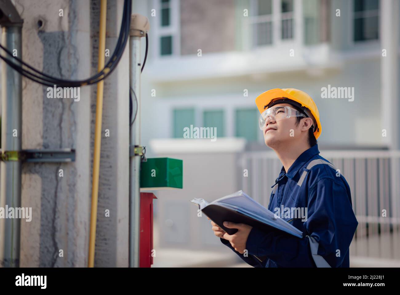 An Engineer is reading a document and checking the communication line ...