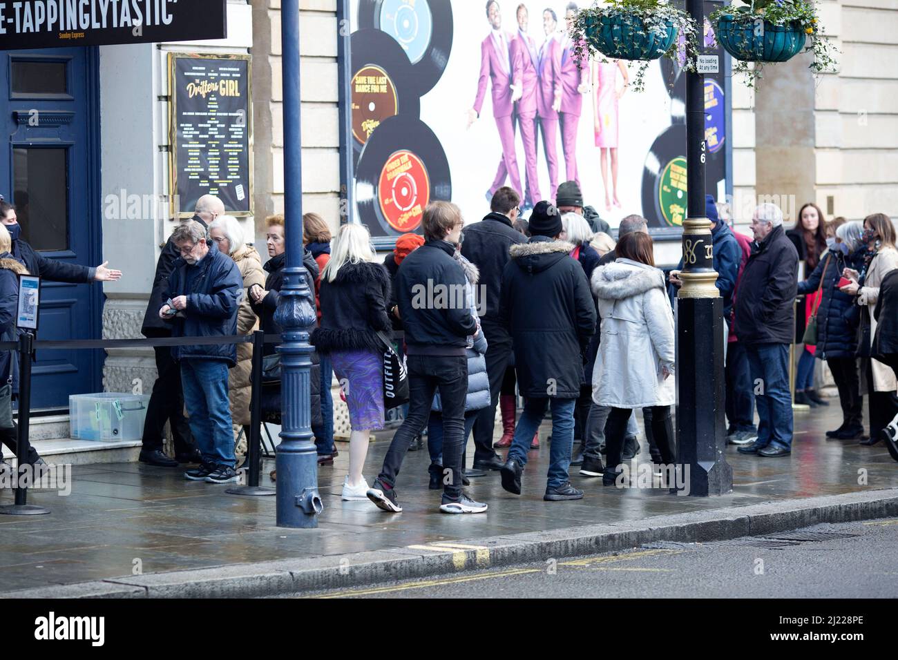 People queue outside the Garrick Theatre in London after the relaxation ...