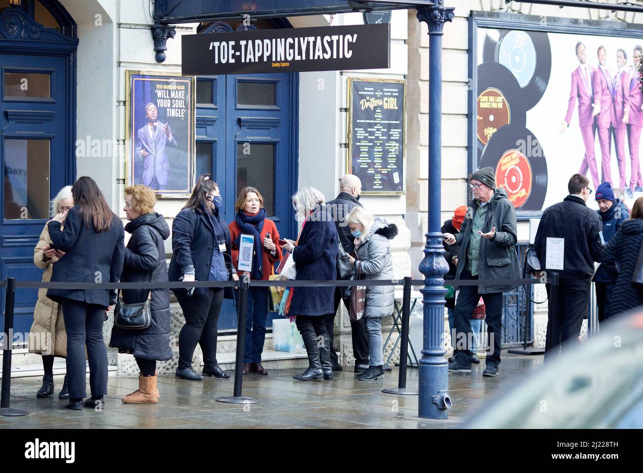 People queue outside the Garrick Theatre in London after the relaxation ...