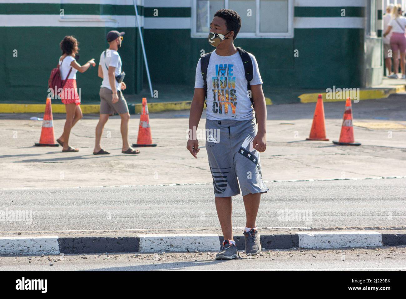 A. young Afro-Caribbean Cuban man wearing up-to-date clothes is seen ...