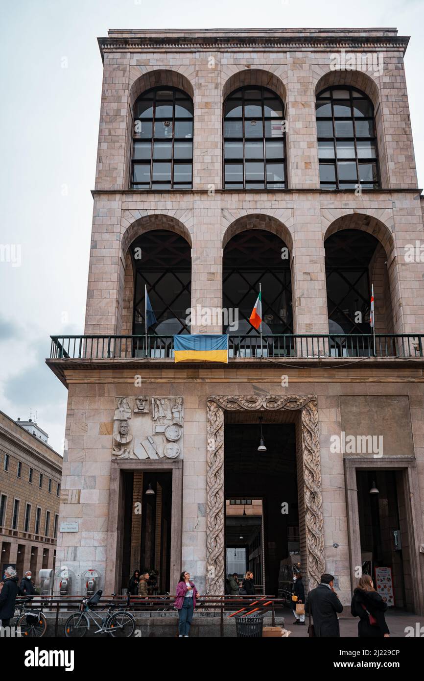 A vertical shot of the Ukraine flag raised in Milan Domo square, Italy ...
