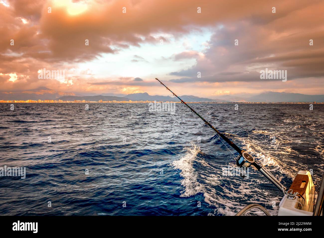 Rod with the coil fixed onboard the vessel Stock Photo - Alamy