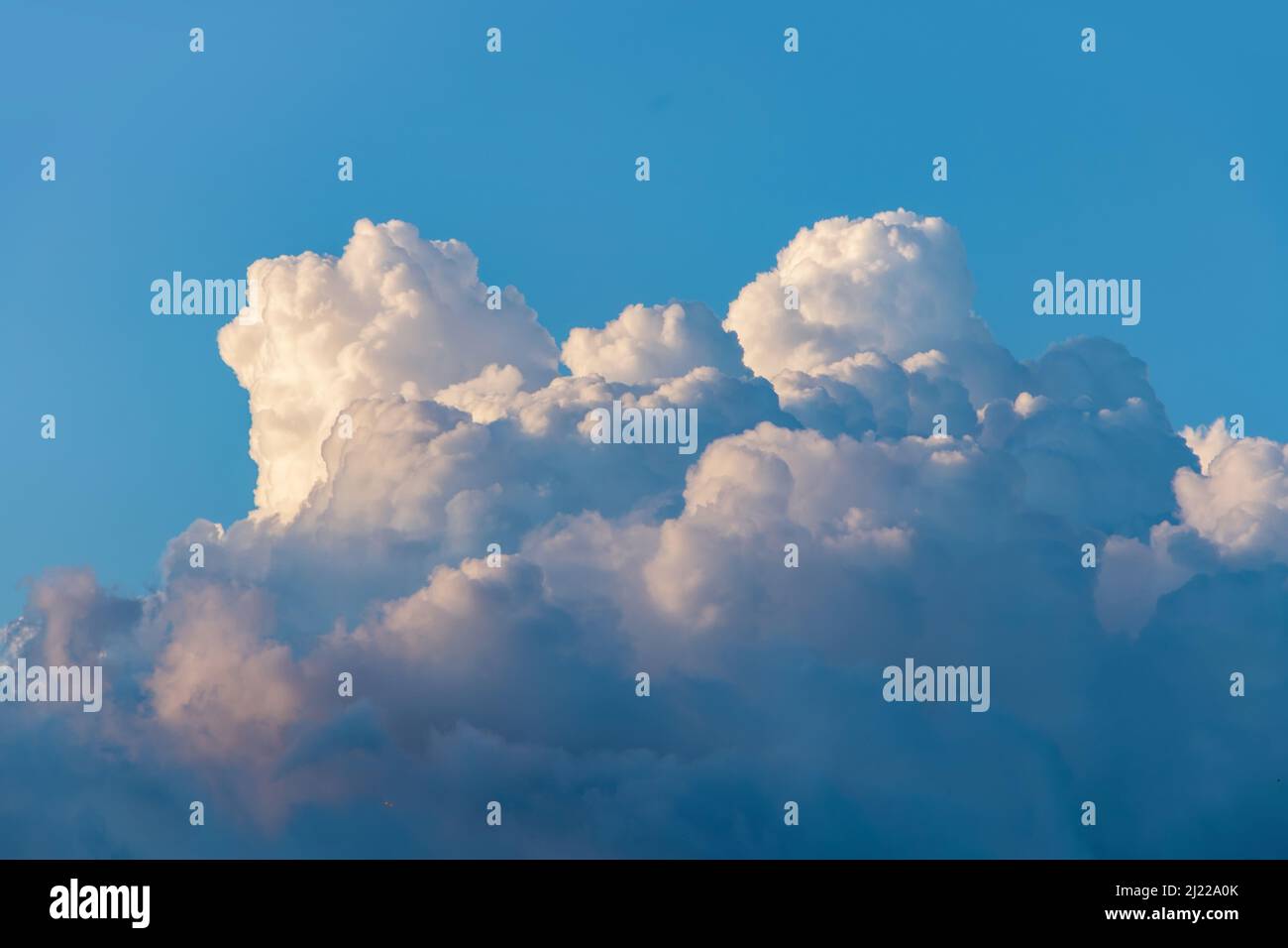 Cumulus sunset clouds with sun setting down Stock Photo - Alamy