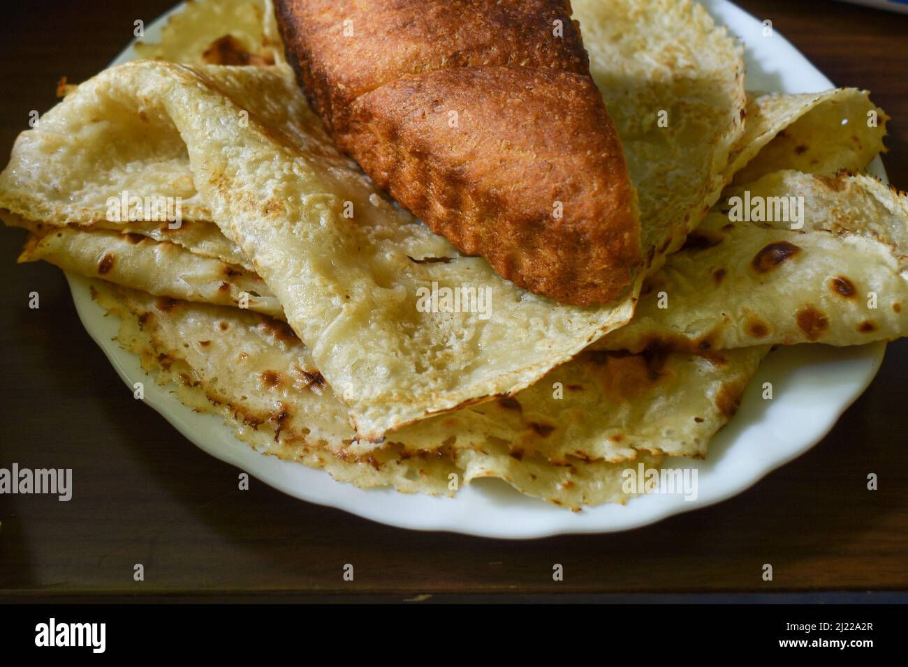A piece of bread and Somali traditional flat bread known as sabayaad on ...