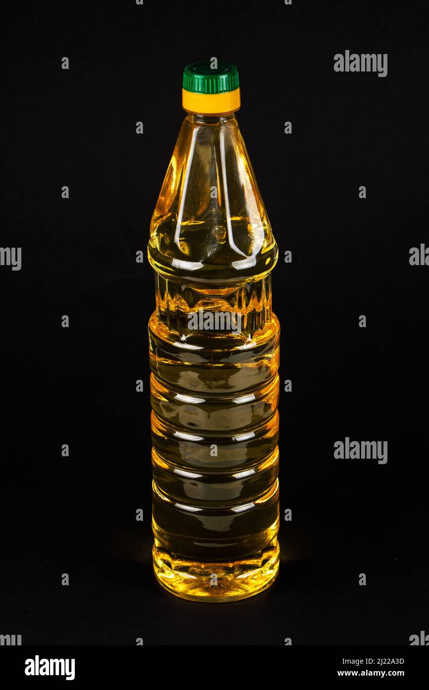 Bottle vegetable oil on black background Stock Photo - Alamy