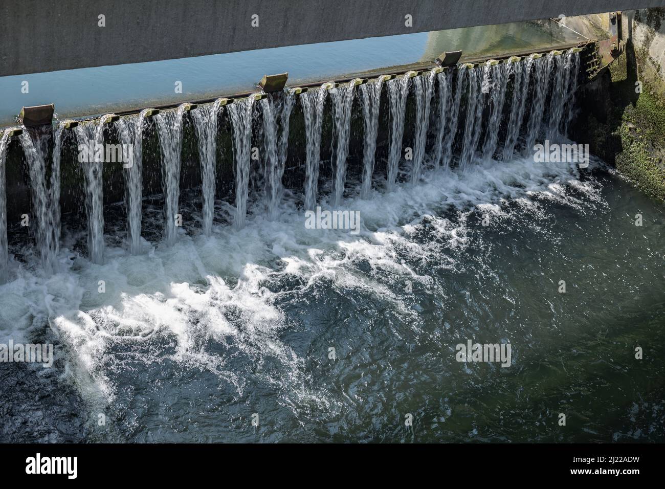 a dam with a waterfall on a river Stock Photo - Alamy