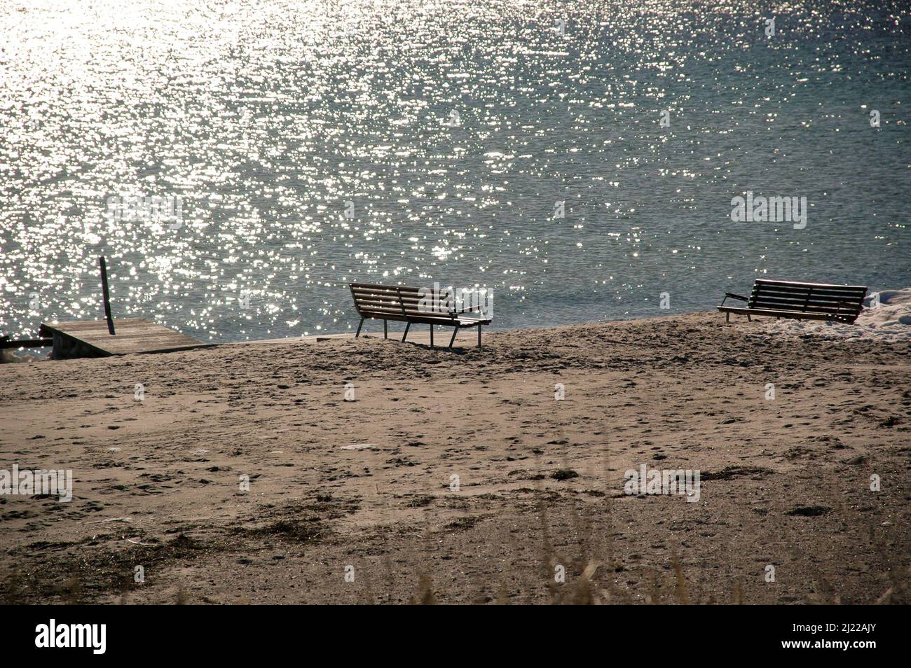Empty benches at the beach Stock Photo - Alamy