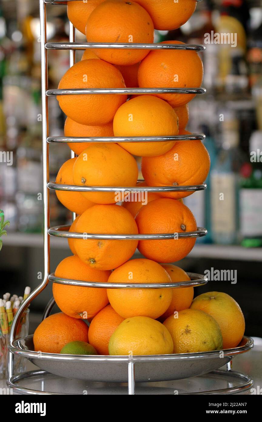Many oranges in a special container at a bar counter Stock Photo - Alamy