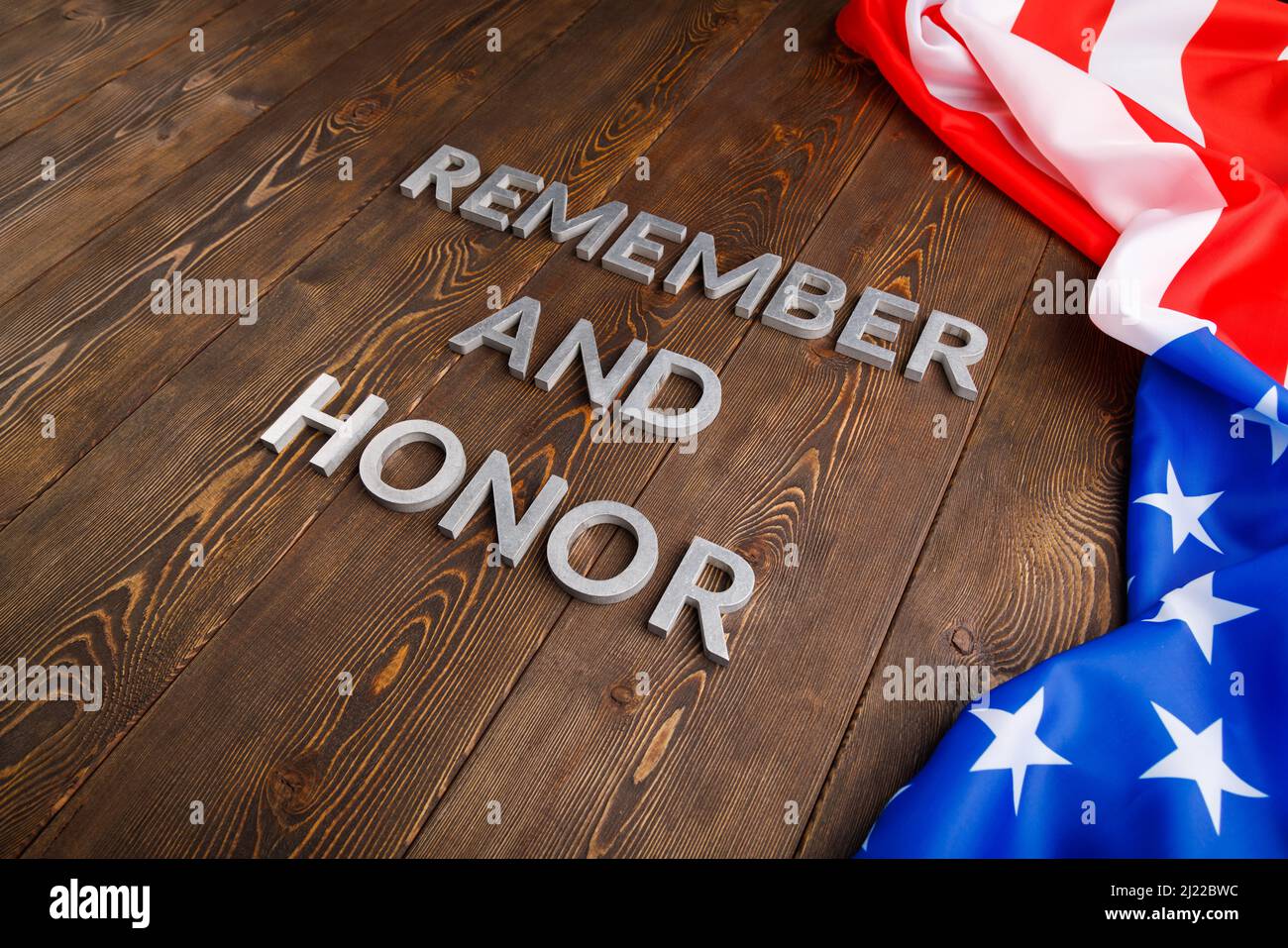 words remember and honor laid with silver metal letters on wooden ...