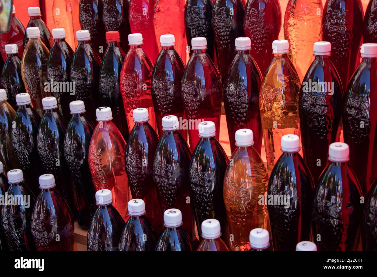 Bottles with handmade liqueur on the shelves. Alcoholic drinks from ...