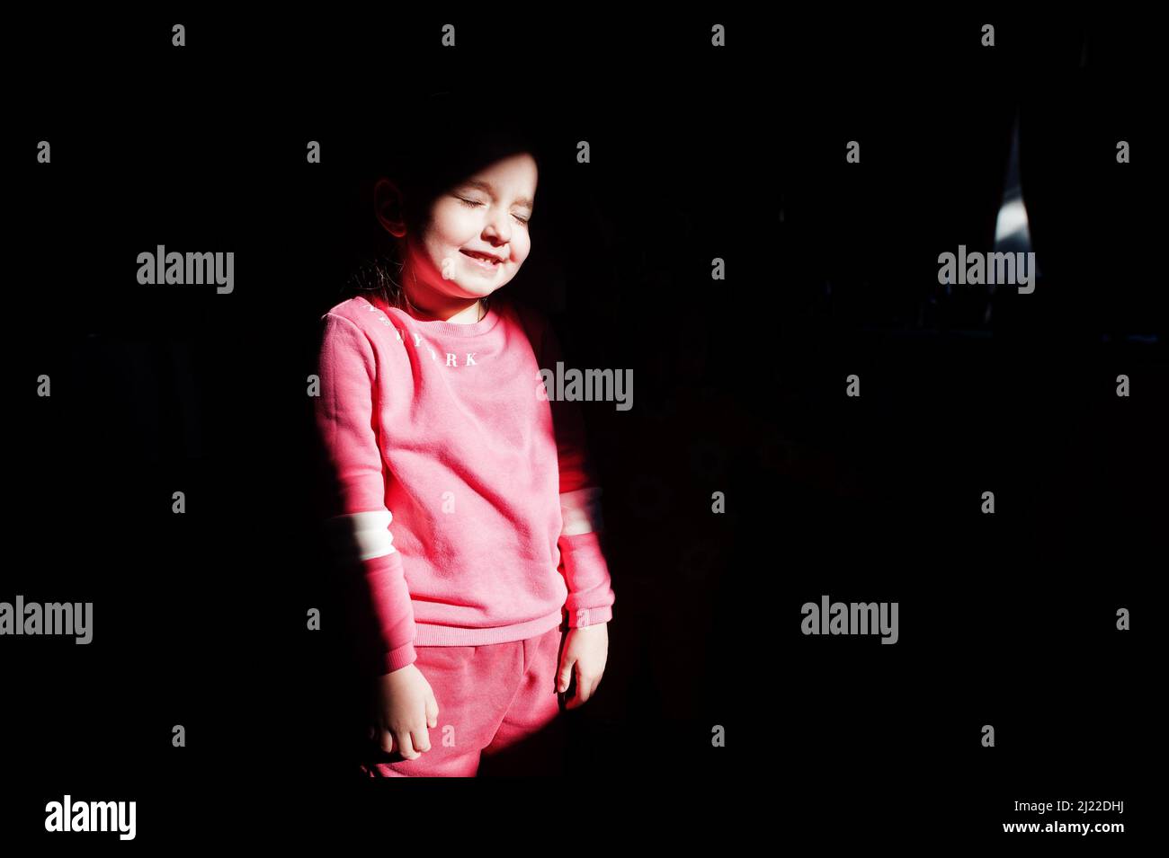 Little girl in the sun and shade smiling Stock Photo - Alamy