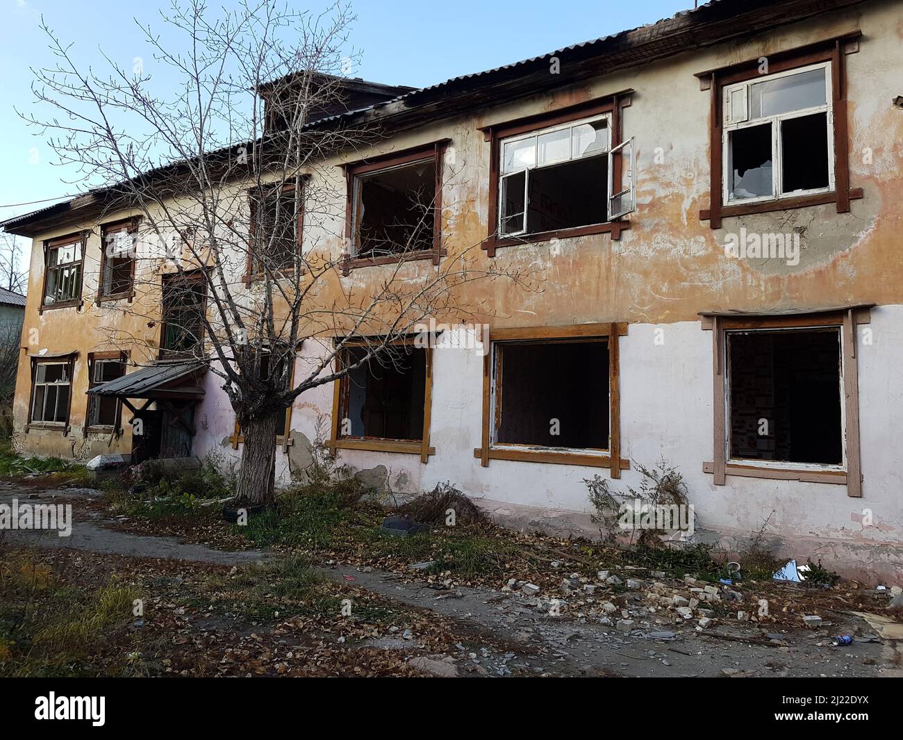 The windows of an old abandoned house with broken glass. An empty ...