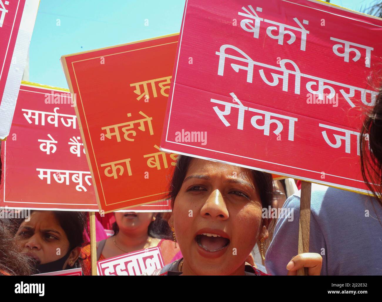 A protester chants slogans while holding a placard expressing her ...