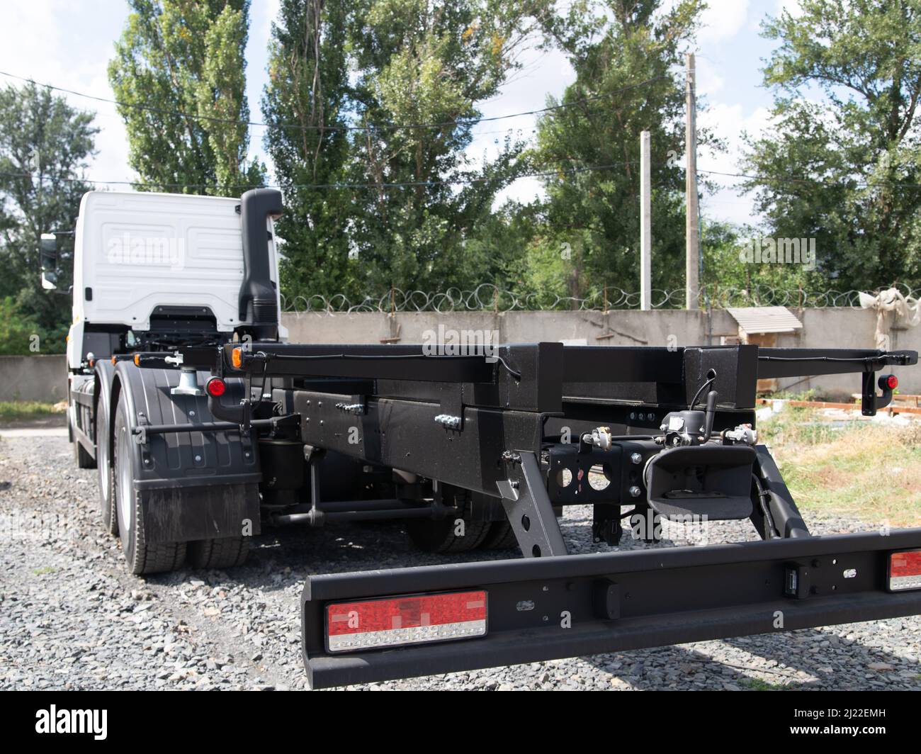 View on tipper truck chassis back, wheels and tires, rear red lights ...