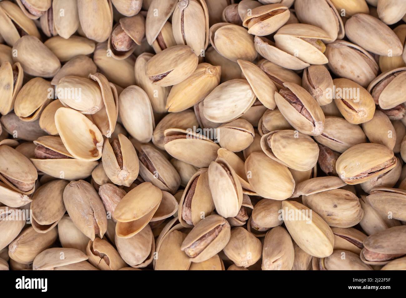 Roasted and salted pistachios in shell texture, background Stock Photo - Alamy