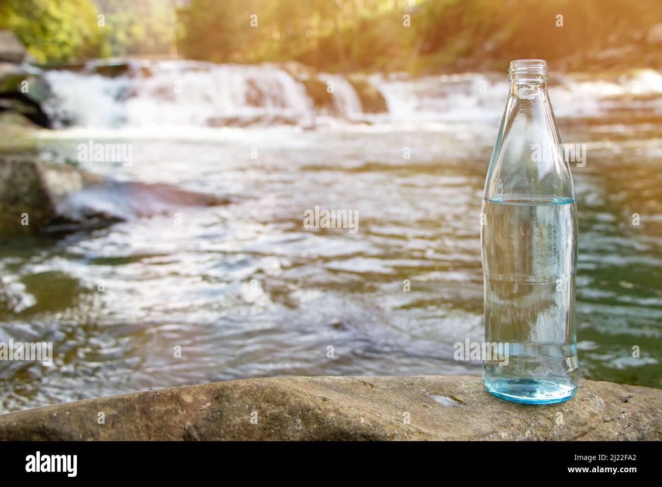 Natural drinking water in a bottle on nature background river Stock ...